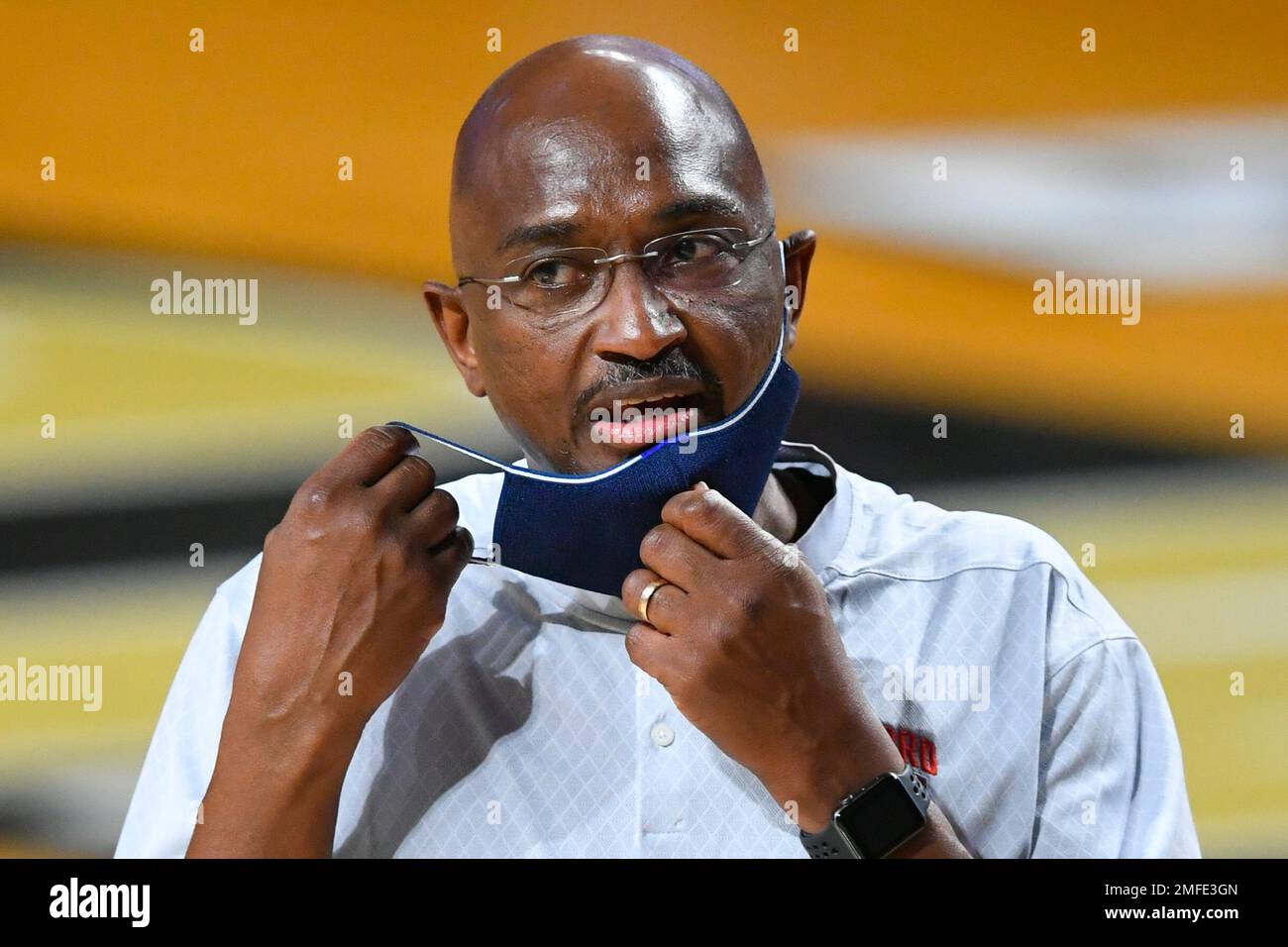 Radford head coach Mike Jones pulls his mask down to be heard by ...