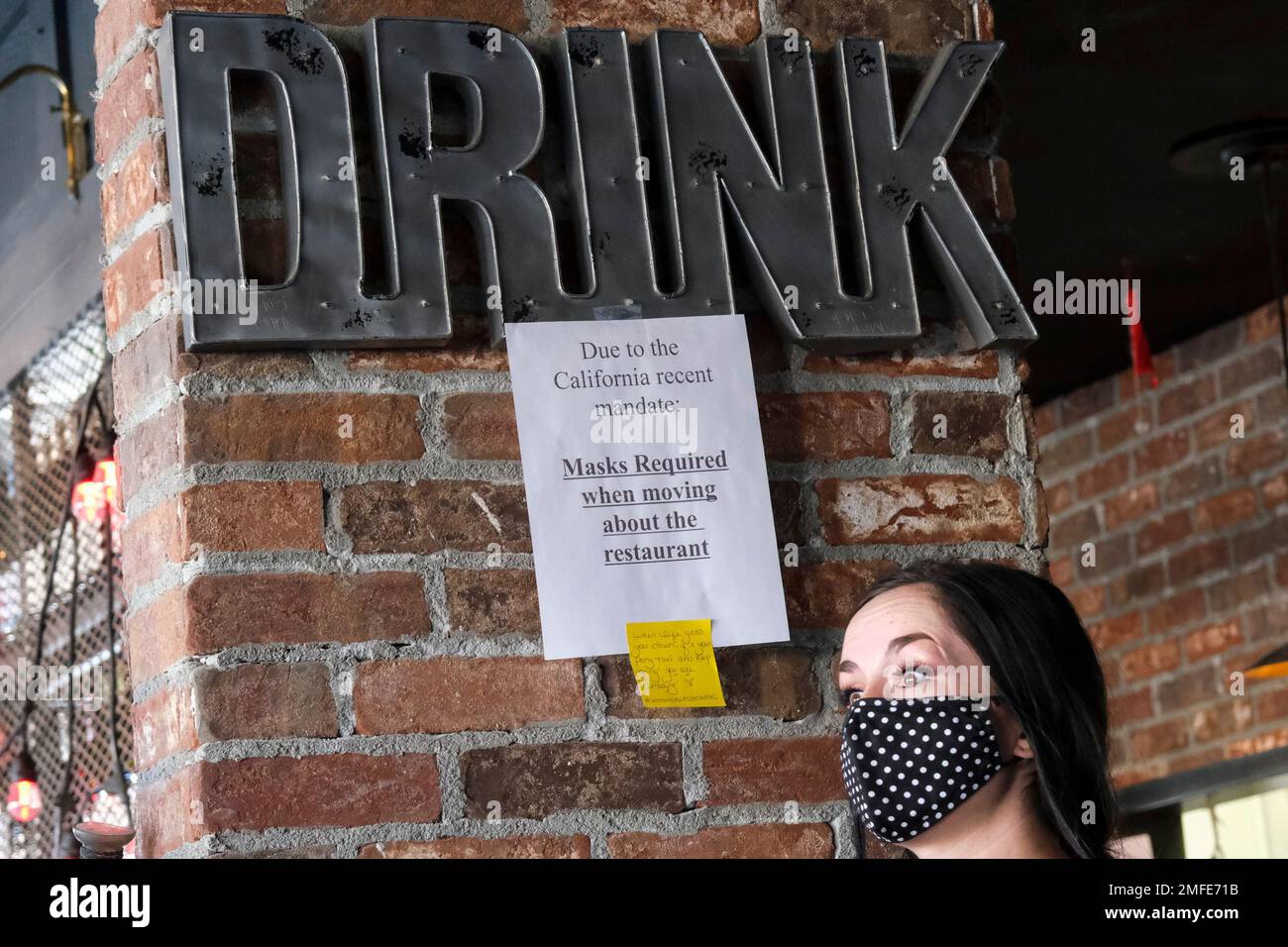 Waitress Penny Thompson is seen in front of a notice, that reminds ...