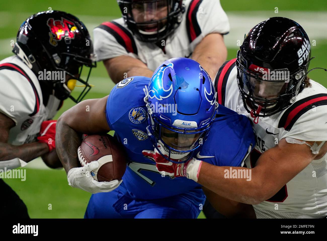 Buffalo running back Ron Cook Jr. (2) is tackled by Ball State's Tye ...