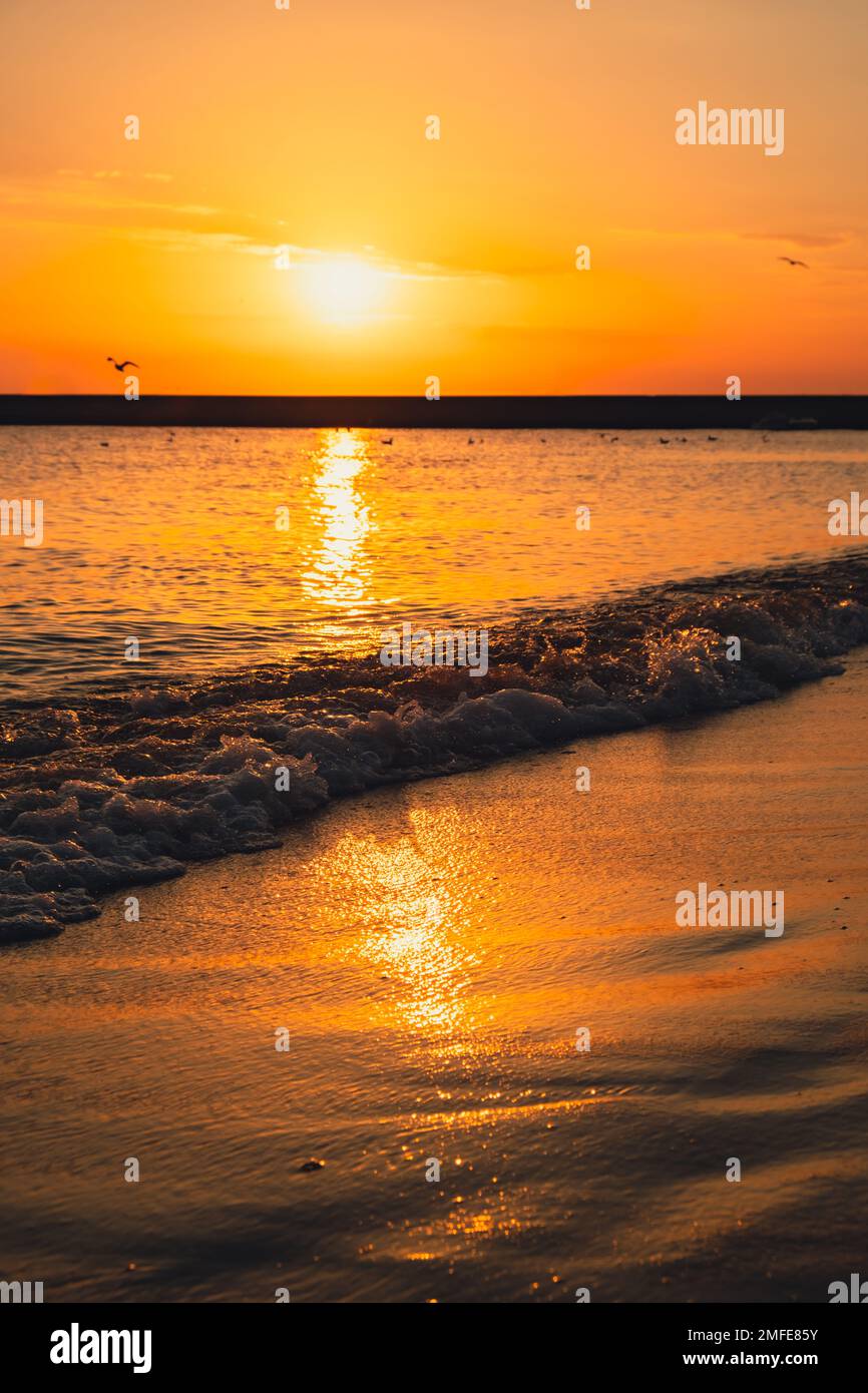 Yellow sun coming out of the sea hi-res stock photography and images ...