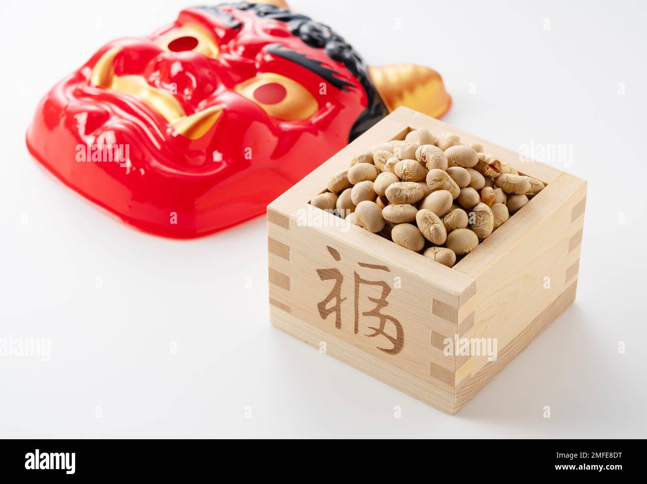 Beans for bean-throwing and masks of ogres placed on a white background ...