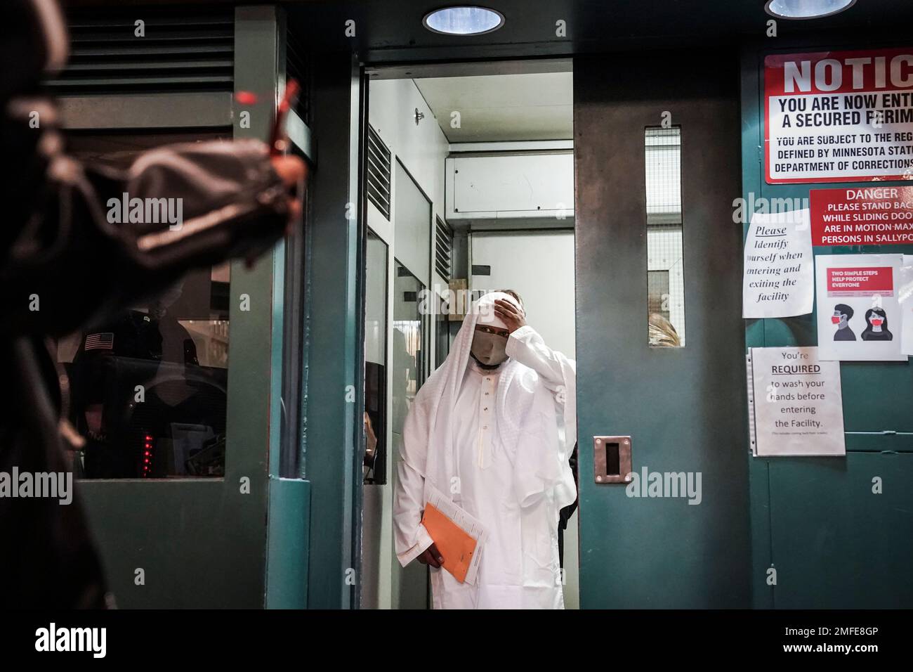 Myon Burrell reacts as he passes through the doors that separate the ...