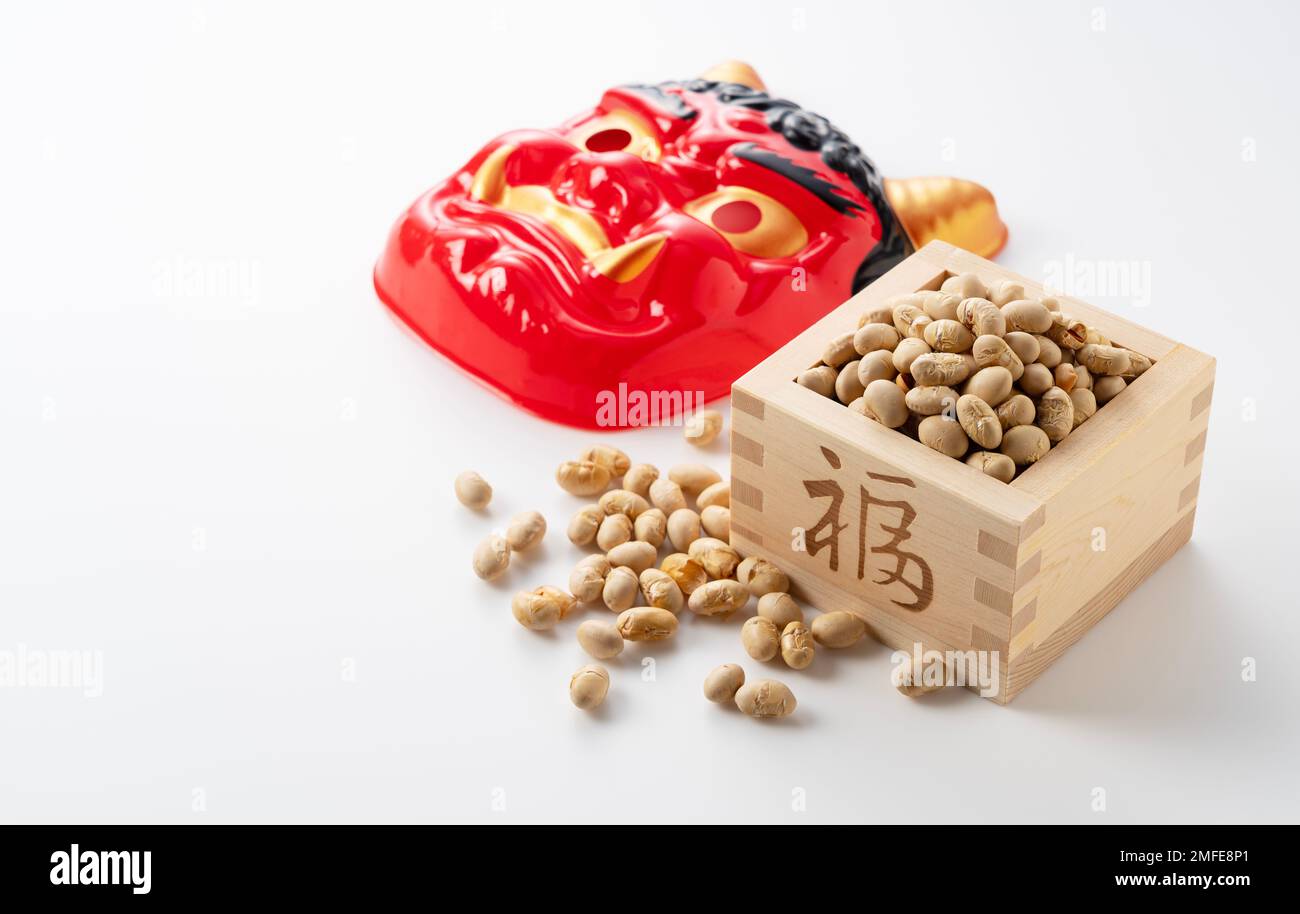 Beans for bean-throwing and masks of ogres placed on a white background ...