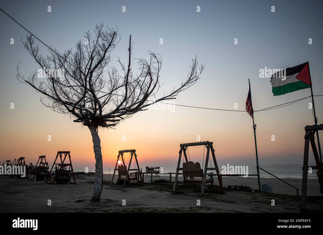 The sun sets over the empty beach during a weekend lockdown to contain ...