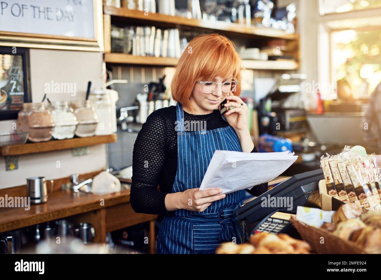 Confirming a big order. a shop owner talking on her cellphone while ...