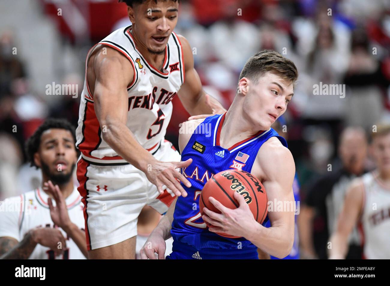 Kansas' Christian Braun (2) gets a rebound under Texas Tech's Micah ...