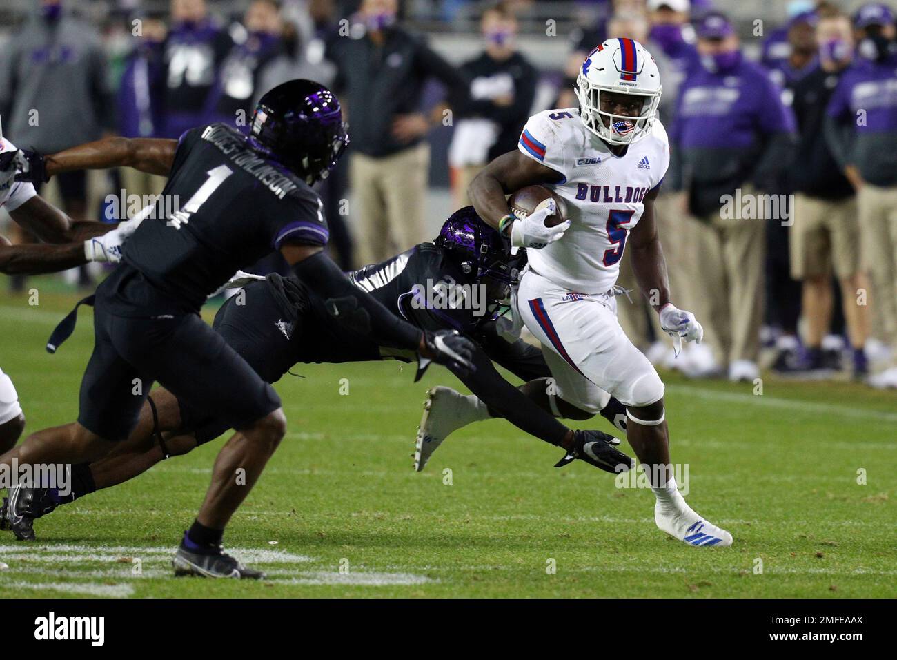 TCU safety La'Kendrick Van Zandt (20) tackles Louisiana Tech wide ...