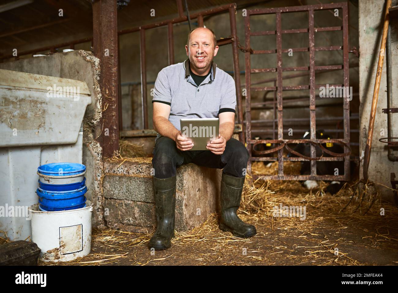 I can run my entire farm on this tablet. Full length portrait of a male ...