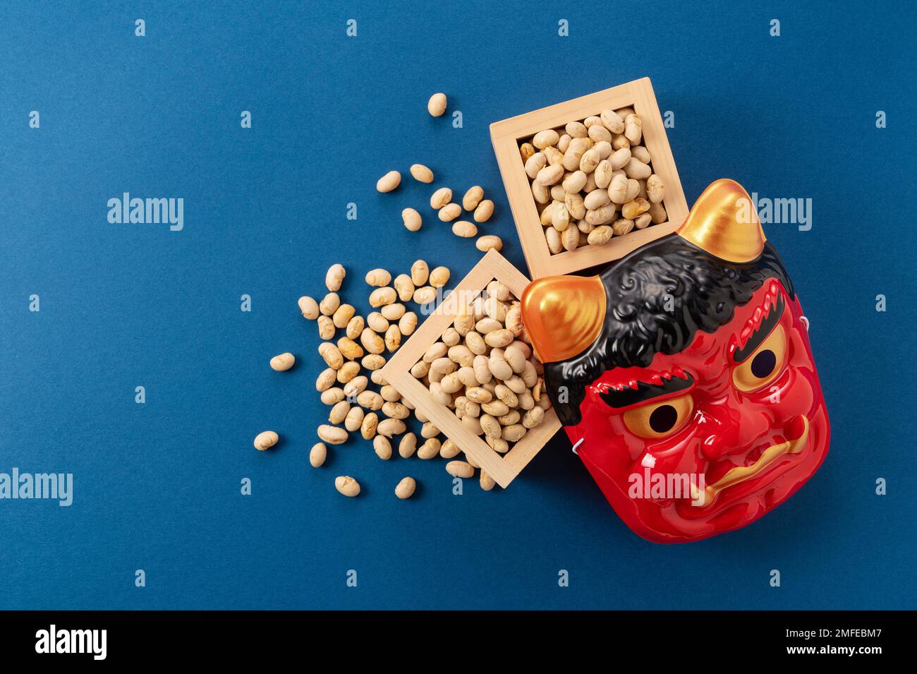 Beans for bean-throwing and masks of ogres placed on a navy blue ...