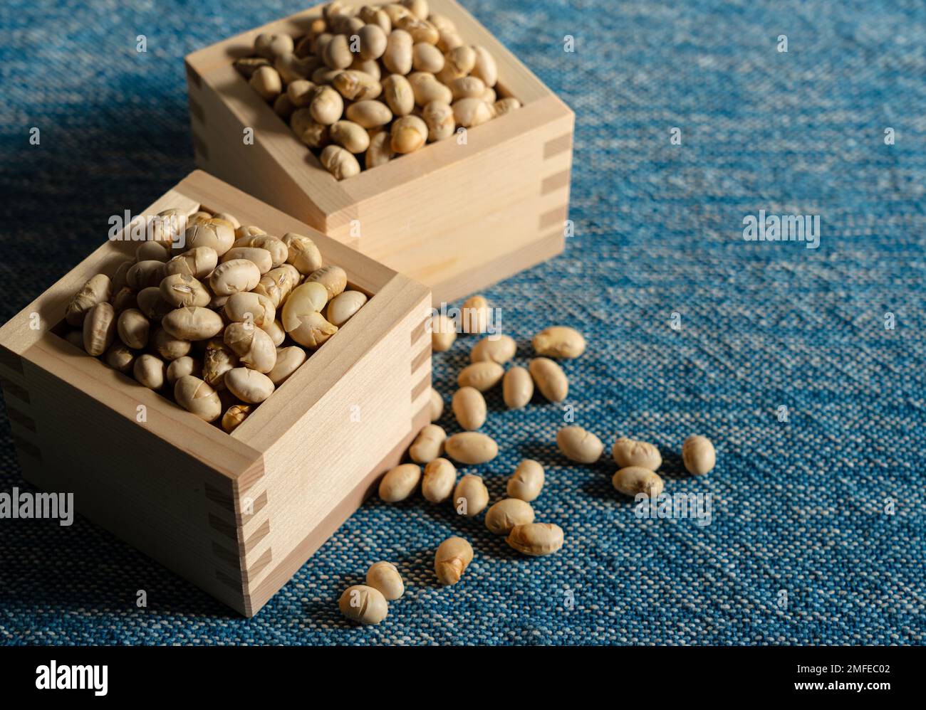 Fukurimame in a wooden bowl placed on a blue cloth. Bean throwing. A ...