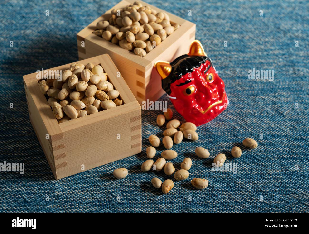 Beans for bean-throwing and masks of ogres placed on a navy blue ...