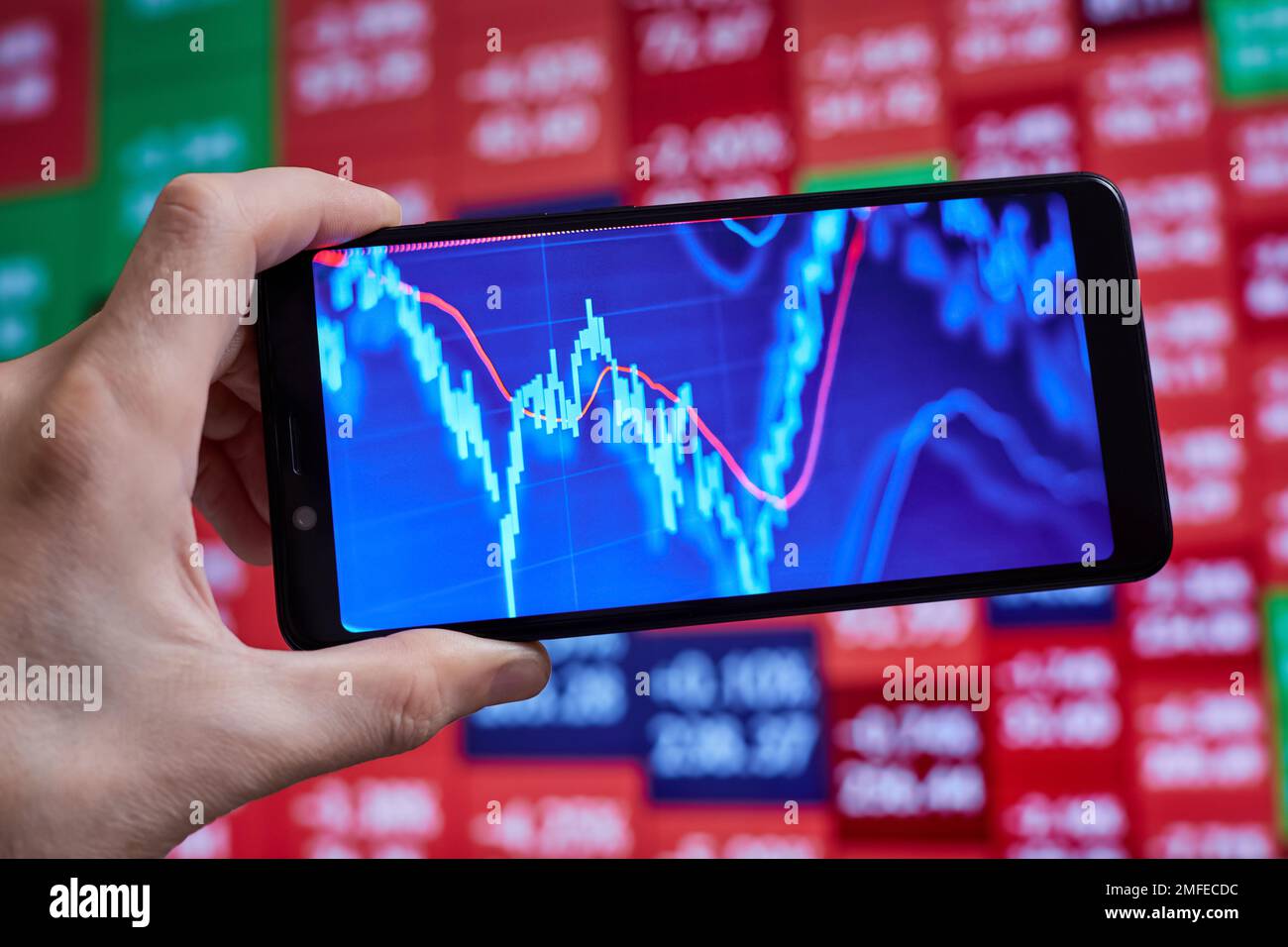 Trader analyzes stock market data in smartphone on the background of ...