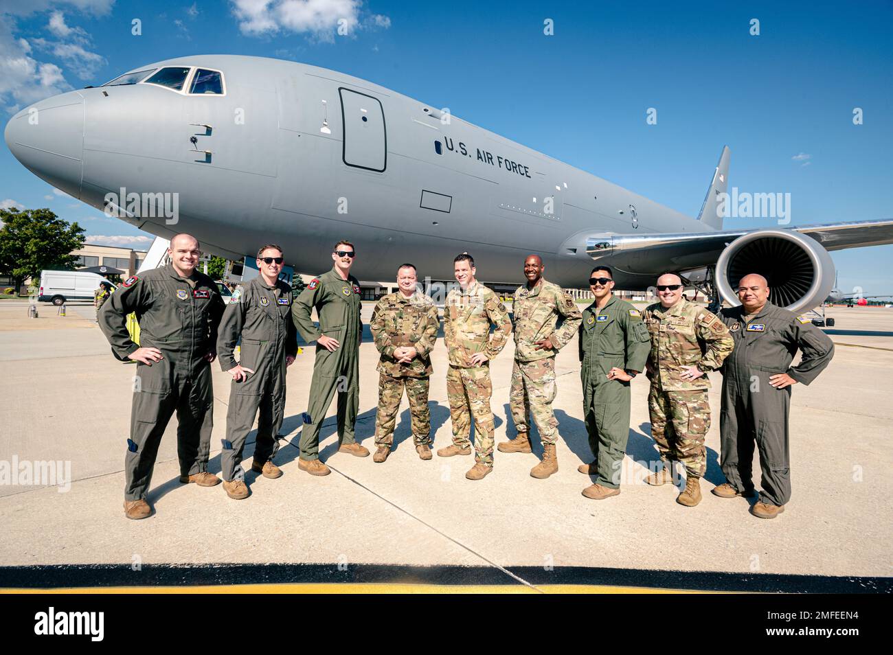 Airmen assigned to the 305th Air Mobility Wing pose in front of a KC ...