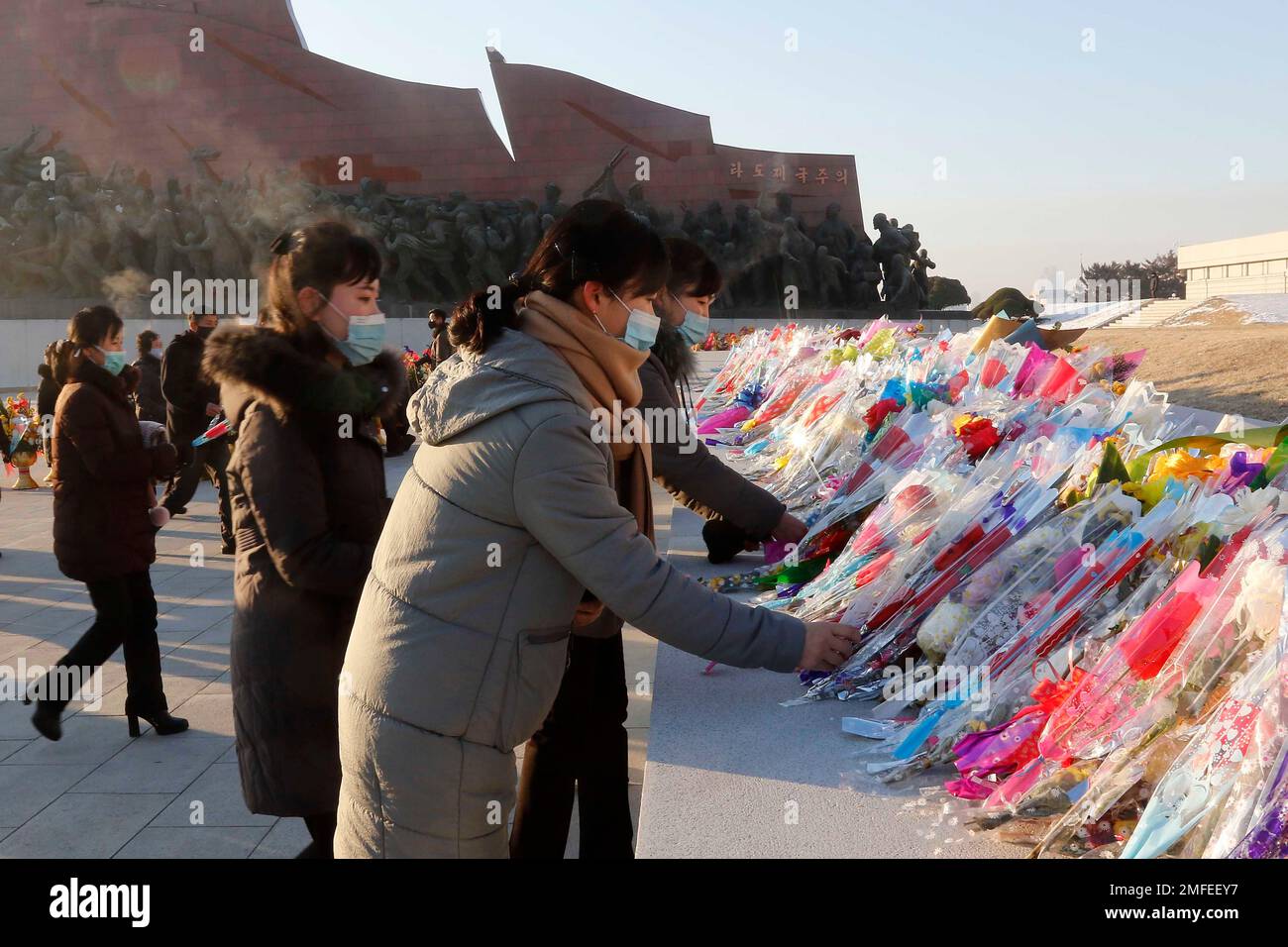 Pyongyang citizens visit Mansu Hill to offer the bouquets of flowers to ...