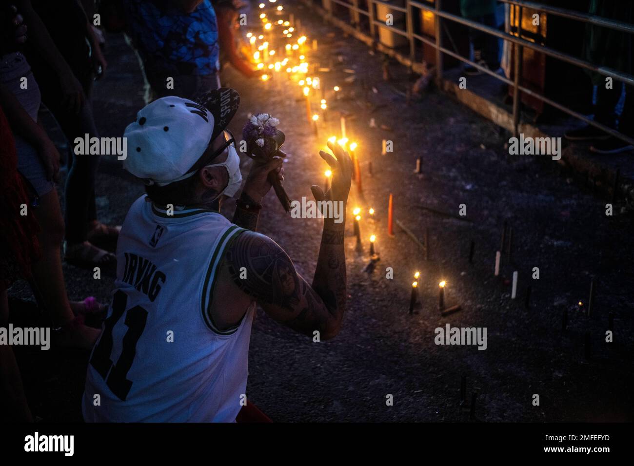 A follower of Saint Lazaro prays during the pilgrimage to the saint's ...