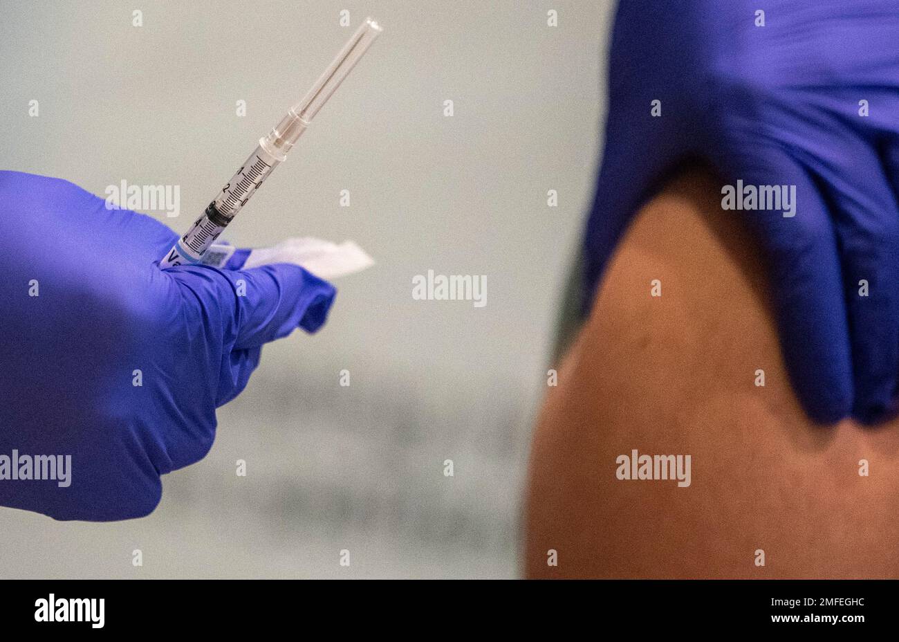 Nurse Eunice Lee prepares to give UCLA physician Russell Johnson an ...