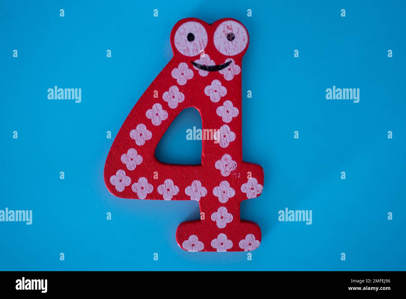 Red number four with eyes on blue background. Isolated blue background ...