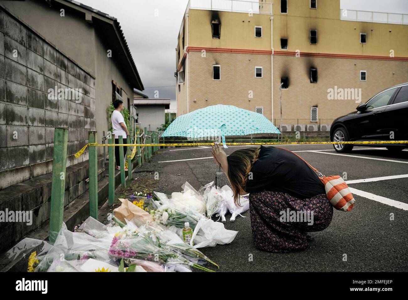 FILE - In this July 19, 2019, file photo, a woman prays at a makeshift ...