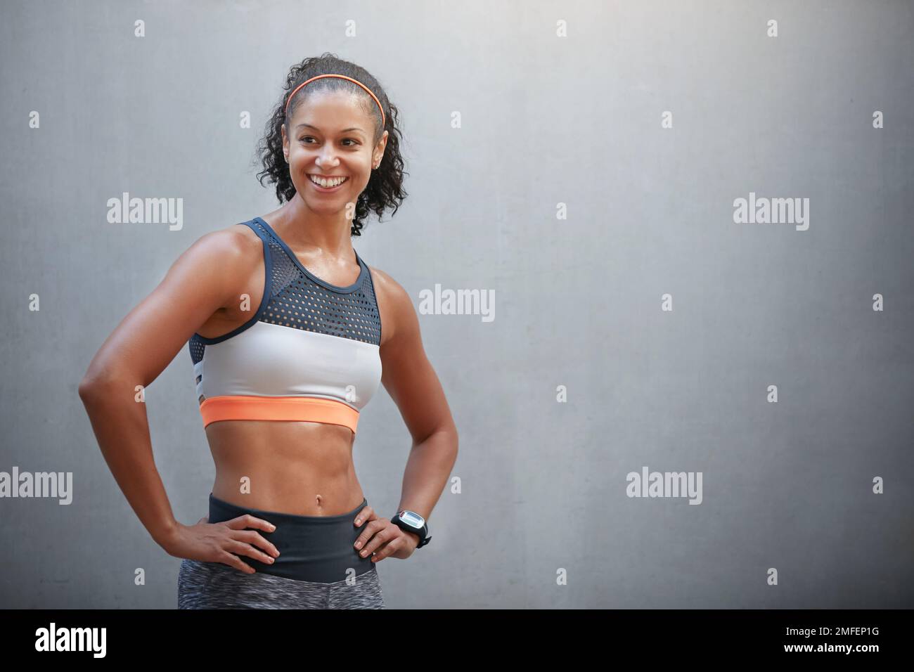 Sculpted through sweat. a sporty young woman standing with her hands on ...