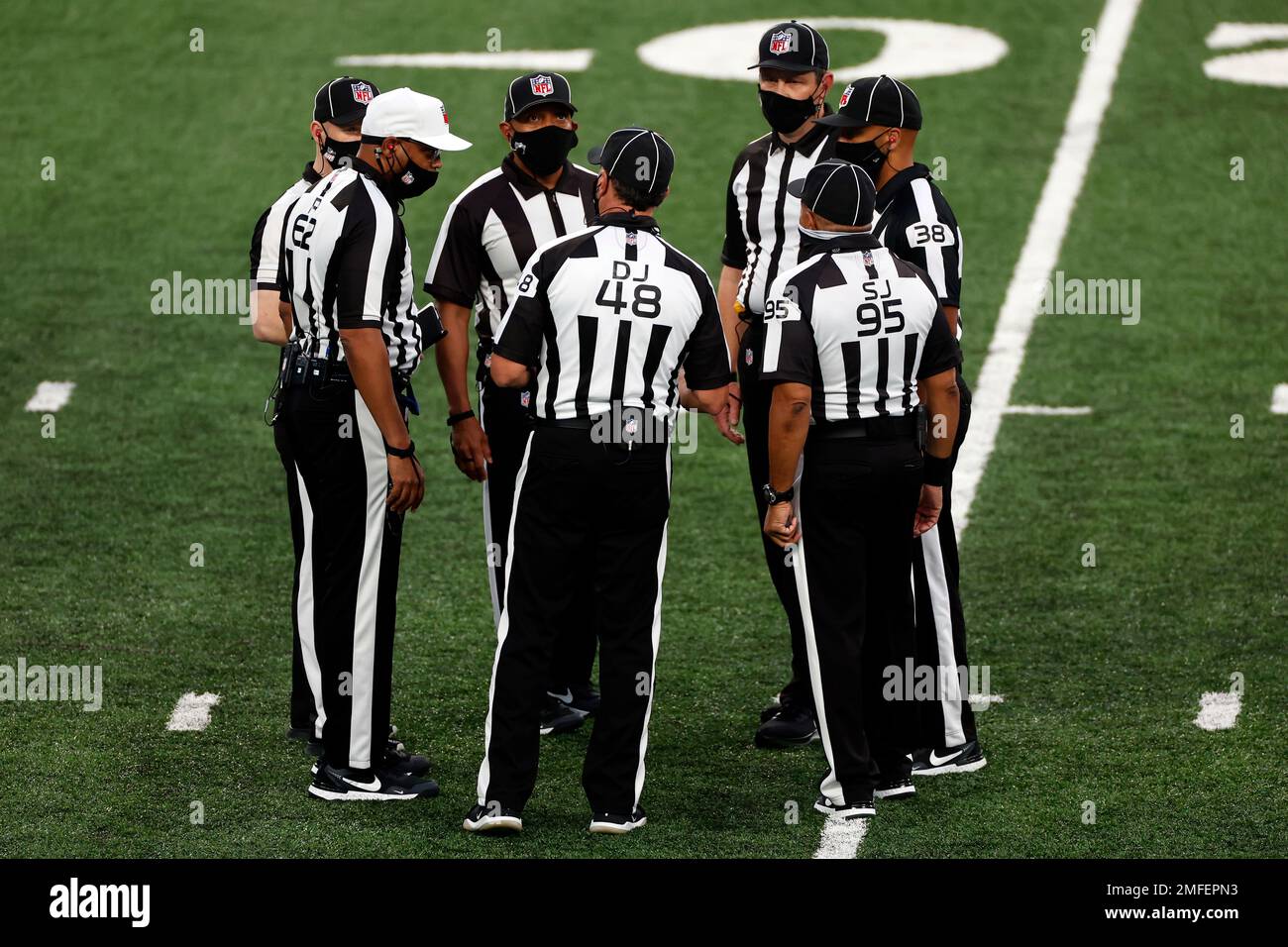 Referee Ron Torbert (62) huddles with his team during an NFL football ...