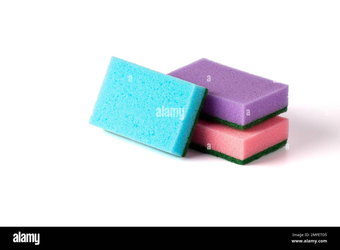 A stack of colored kitchen sponges isolated against white background ...