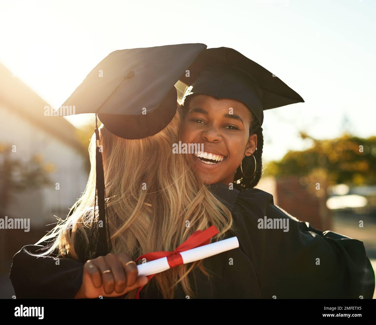 Best friend goals. two happy young women hugging on graduation day ...
