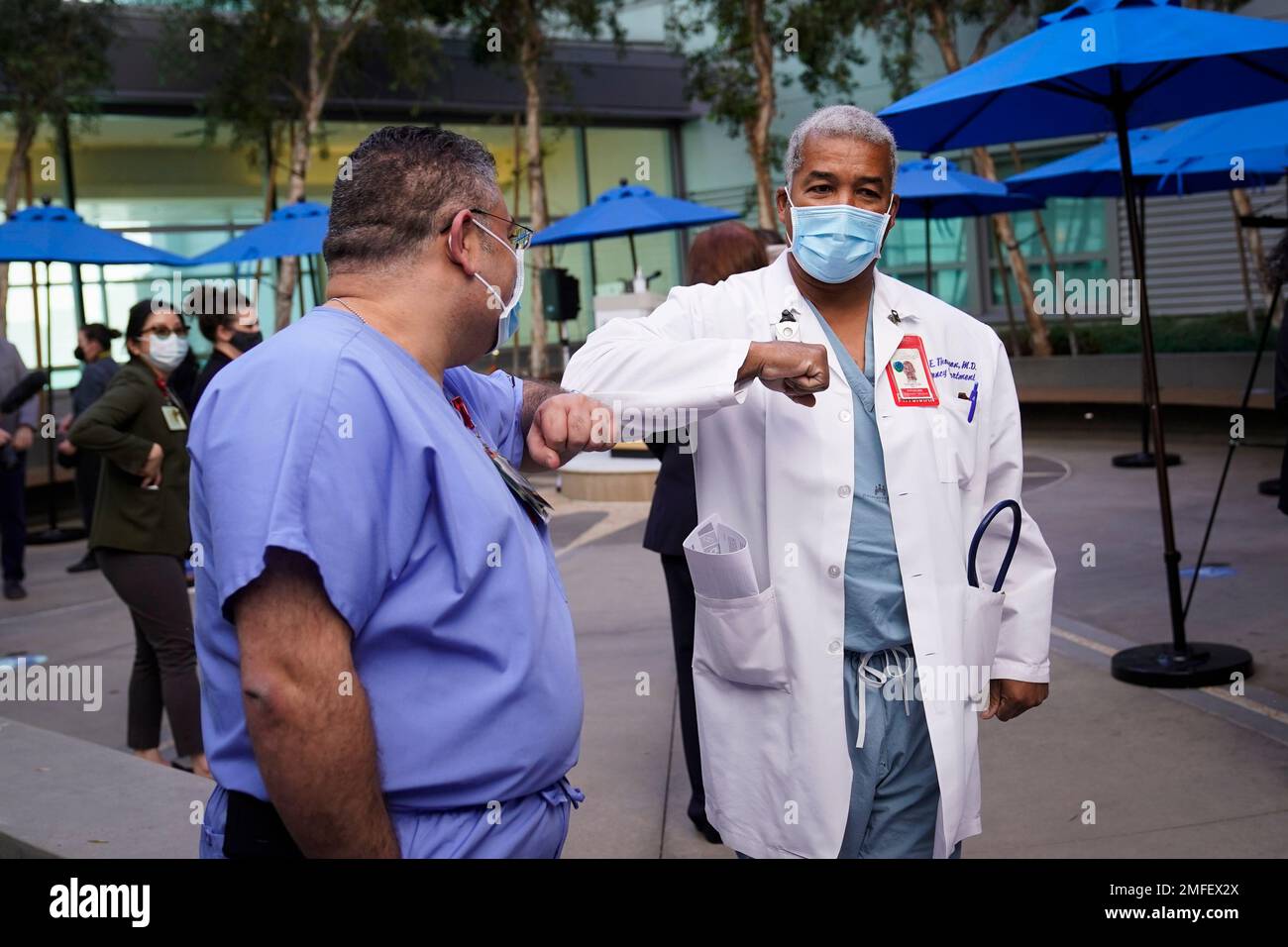 Dr. Brian Thompson, right, is congratulated after getting the Pfizer ...