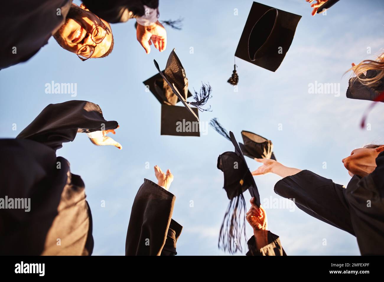 Heres to the future. Low angle shot of a group of young students ...