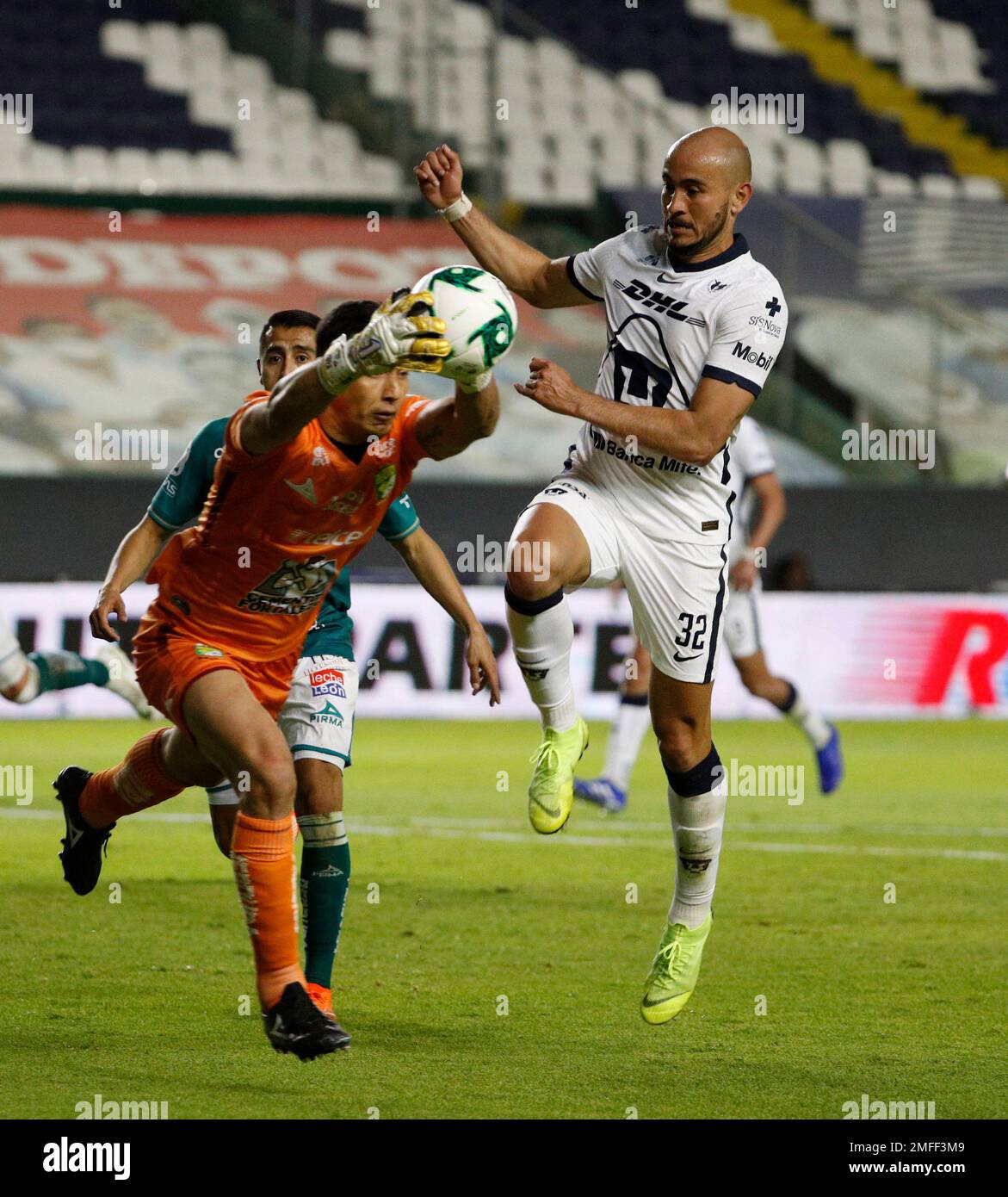 Leon's goalkeeper Rodolfo Cota, left, catches the ball as Pumas' Carlos ...