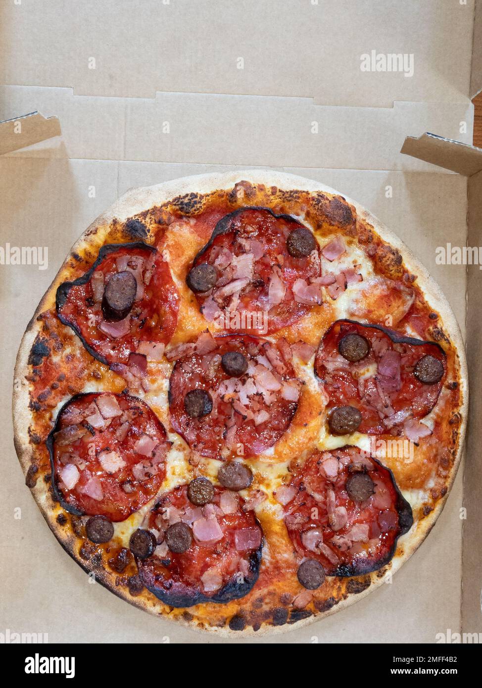 Pizza pepperoni isolated on brown carton box delivery background Stock ...