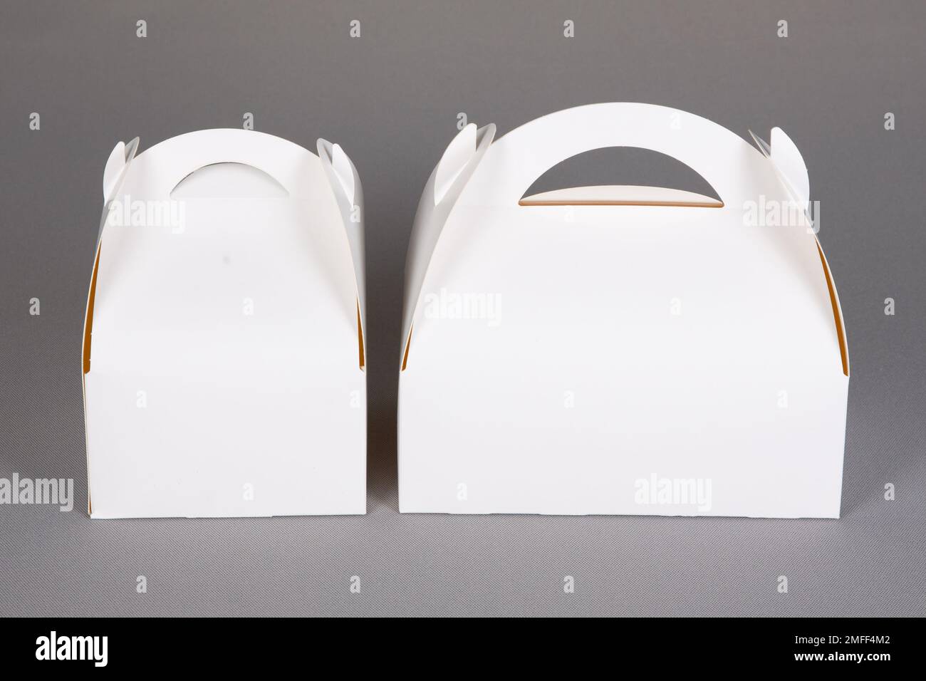 two white mockup blank paper packaging for bakery large and small box ...