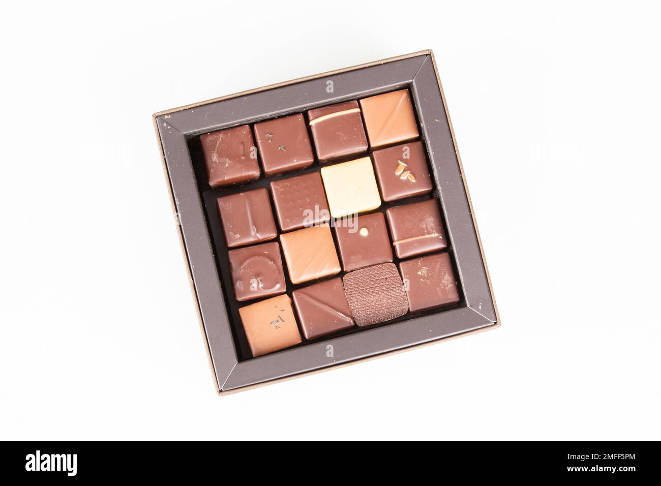 Assortment many small square fine chocolate candies in gift sqare open ...