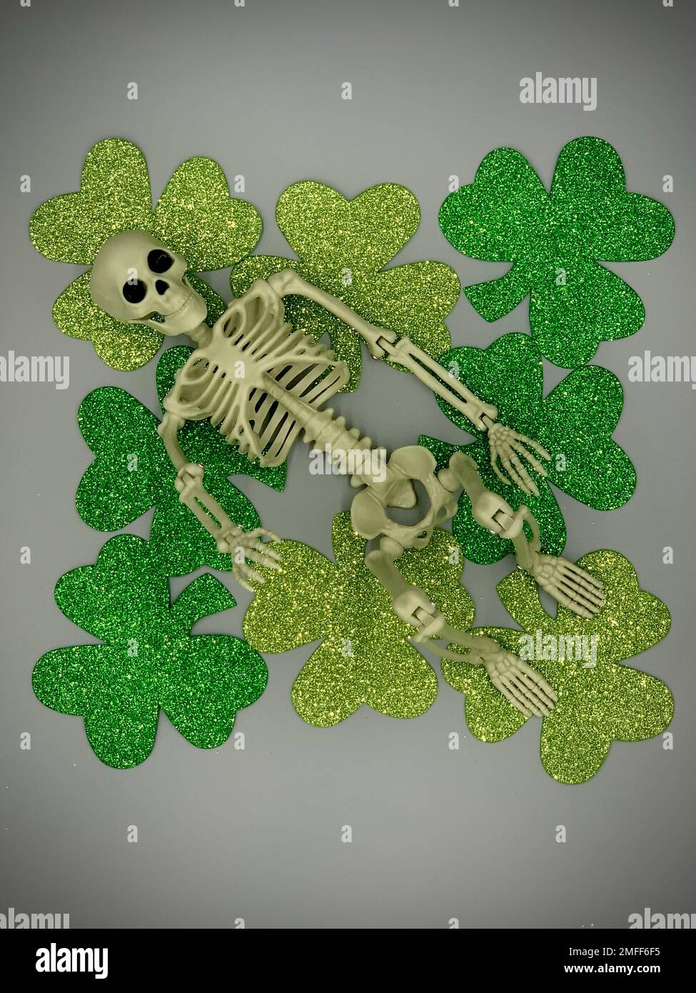 A top view of a skeleton laying on a bunch of clovers Stock Photo - Alamy