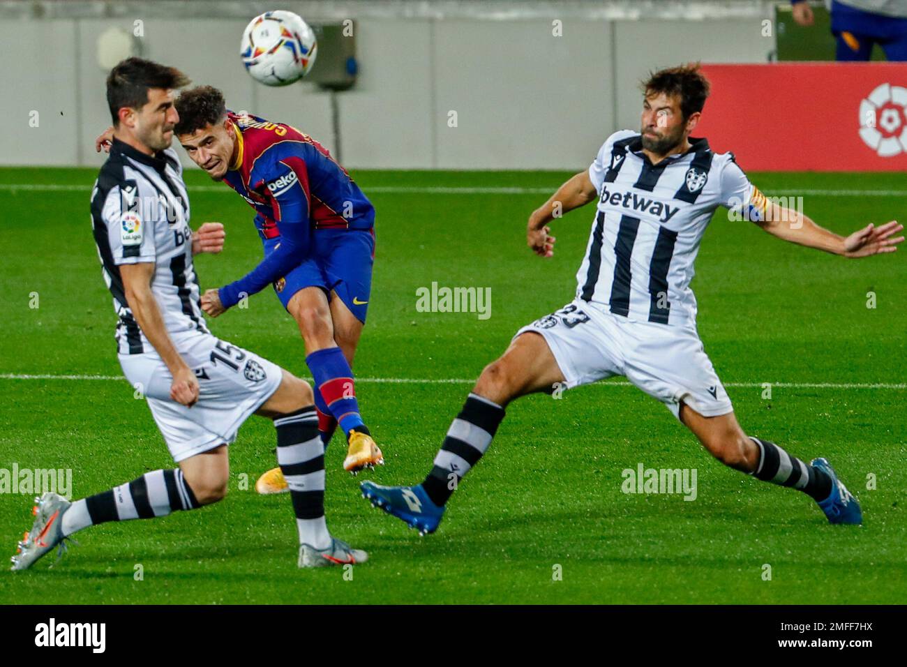 Barcelona's Philippe Coutinho, center, tries a shot during the Spanish ...