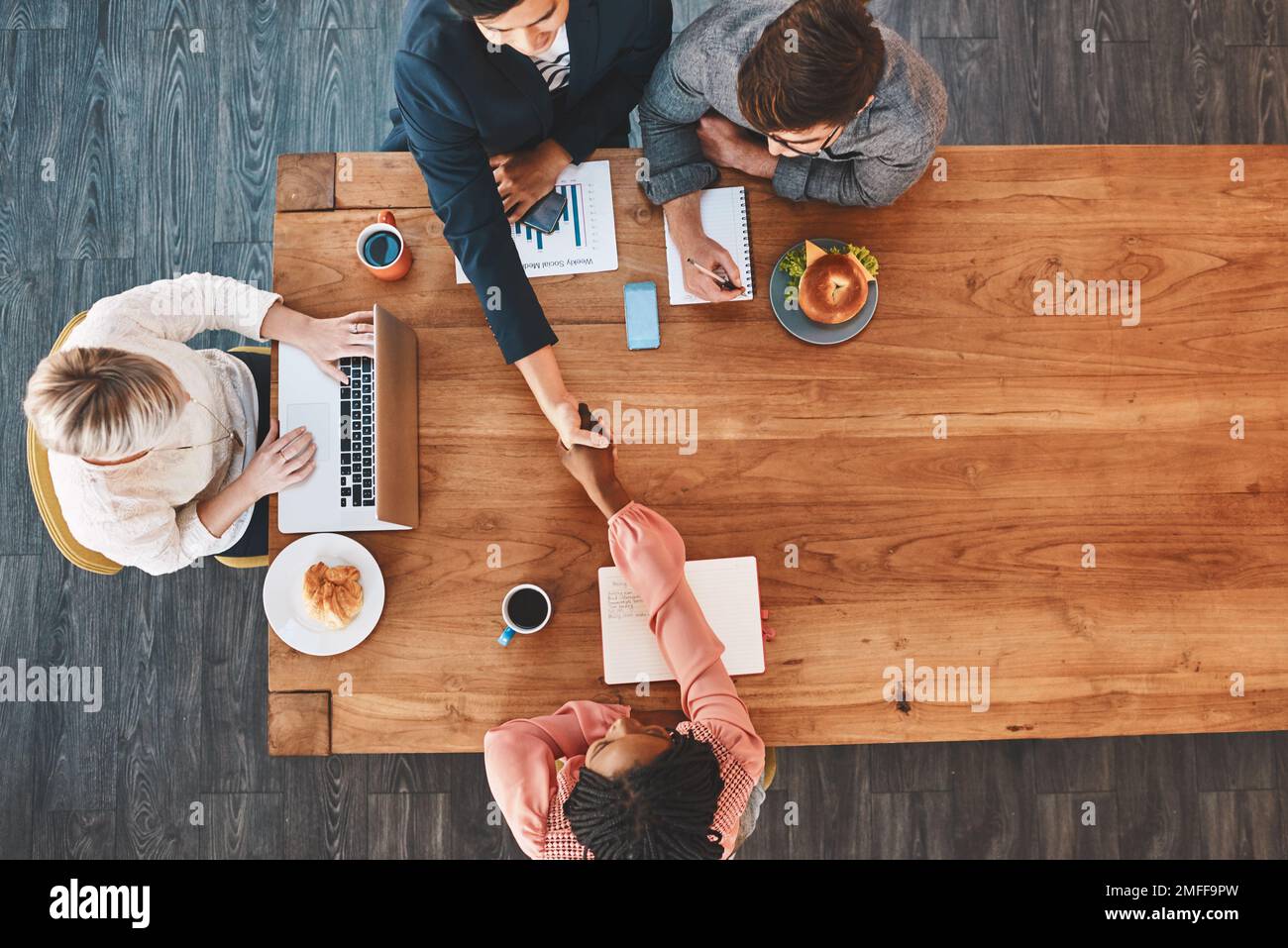 Welcome to the team. High angle shot of a colleagues shaking hands ...