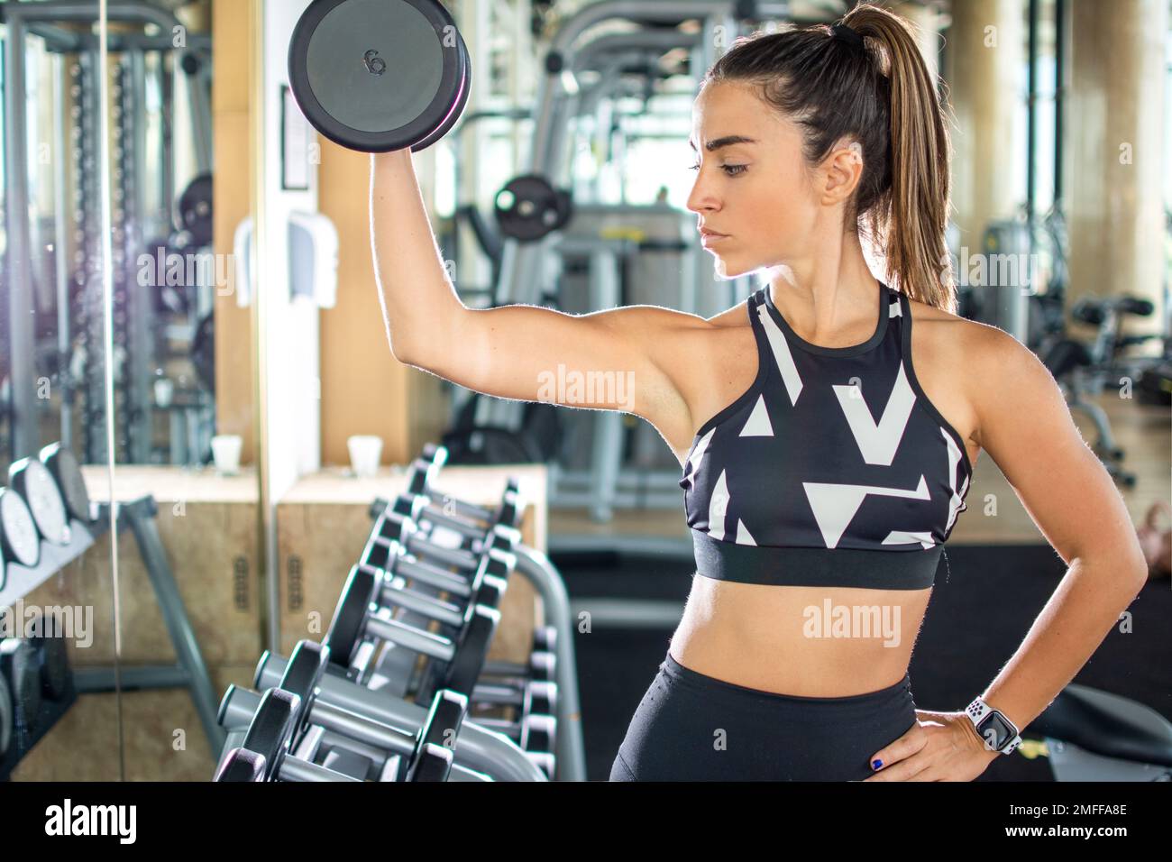 Side view of beautiful attractive young fit sporty woman lifting ...