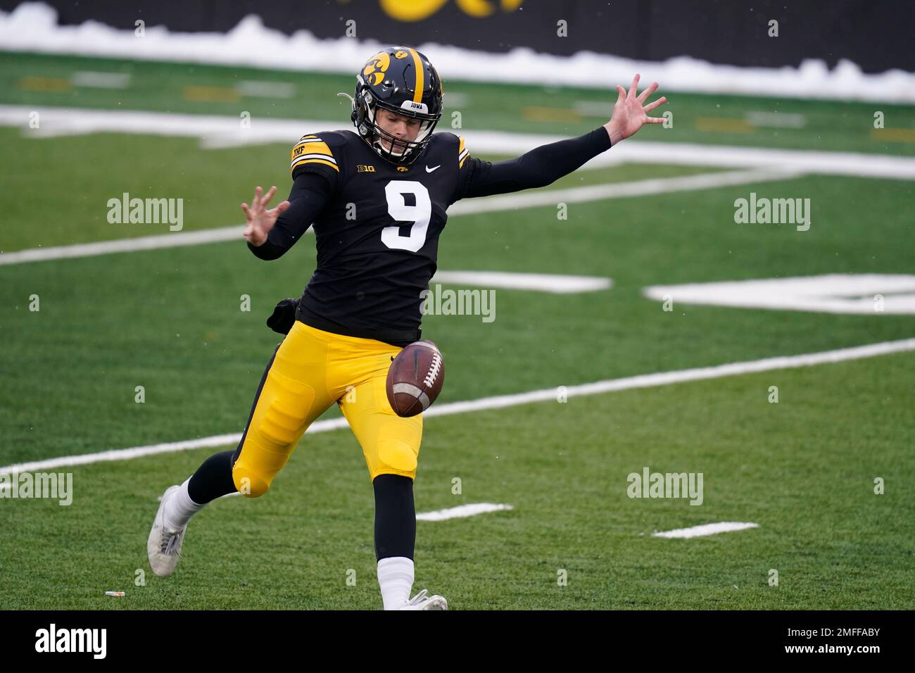 Iowa punter Tory Taylor punts during the first half of an NCAA college ...