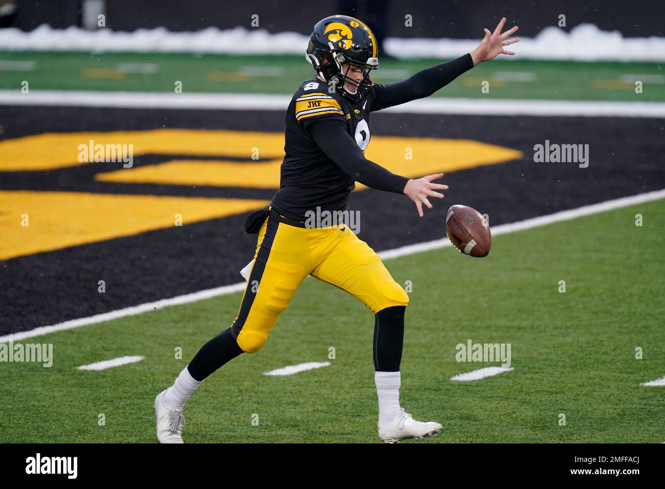 Iowa punter Tory Taylor punts during the first half of an NCAA college ...