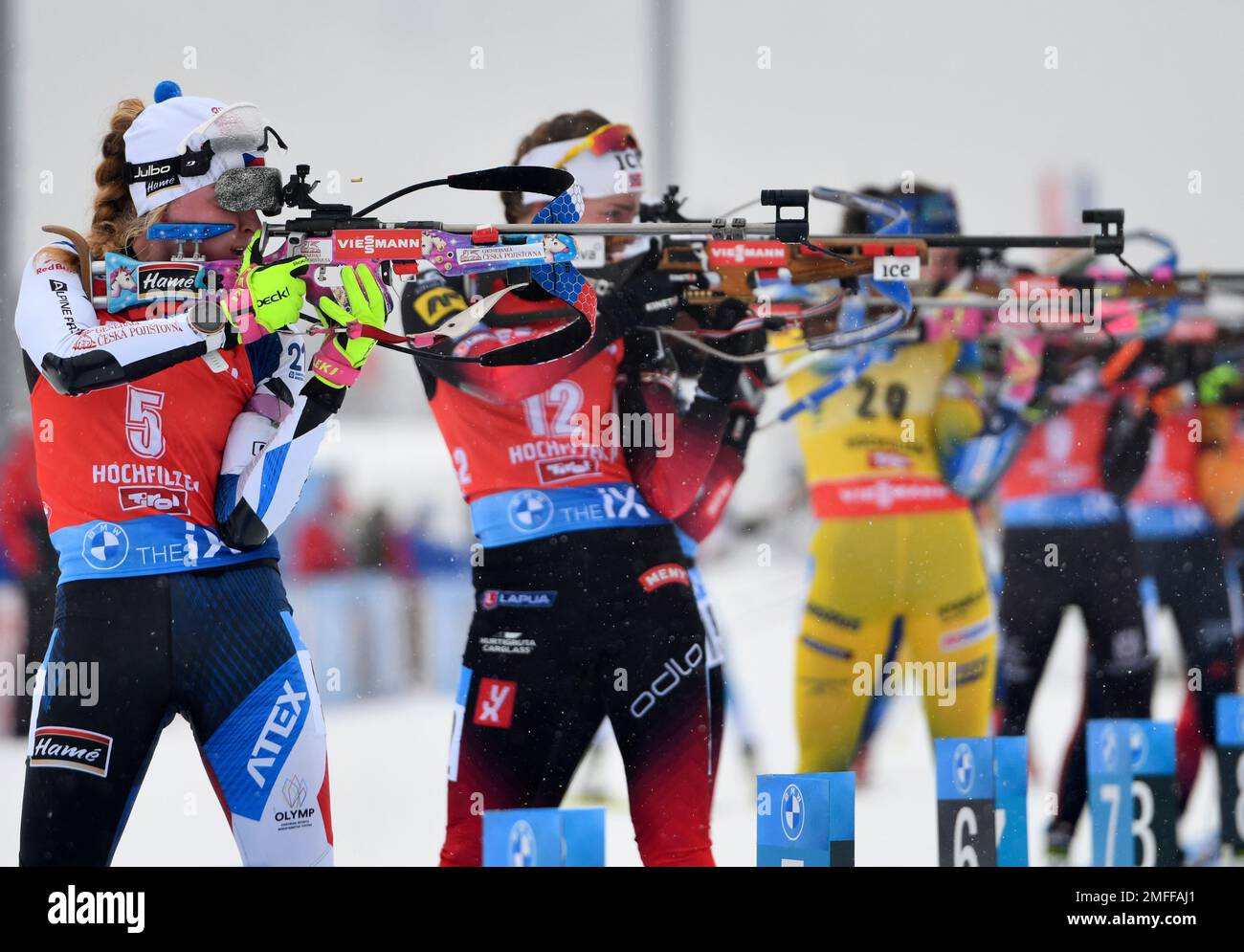 Athletes shoot during the women's 10 km pursuit race at the Biathlon ...