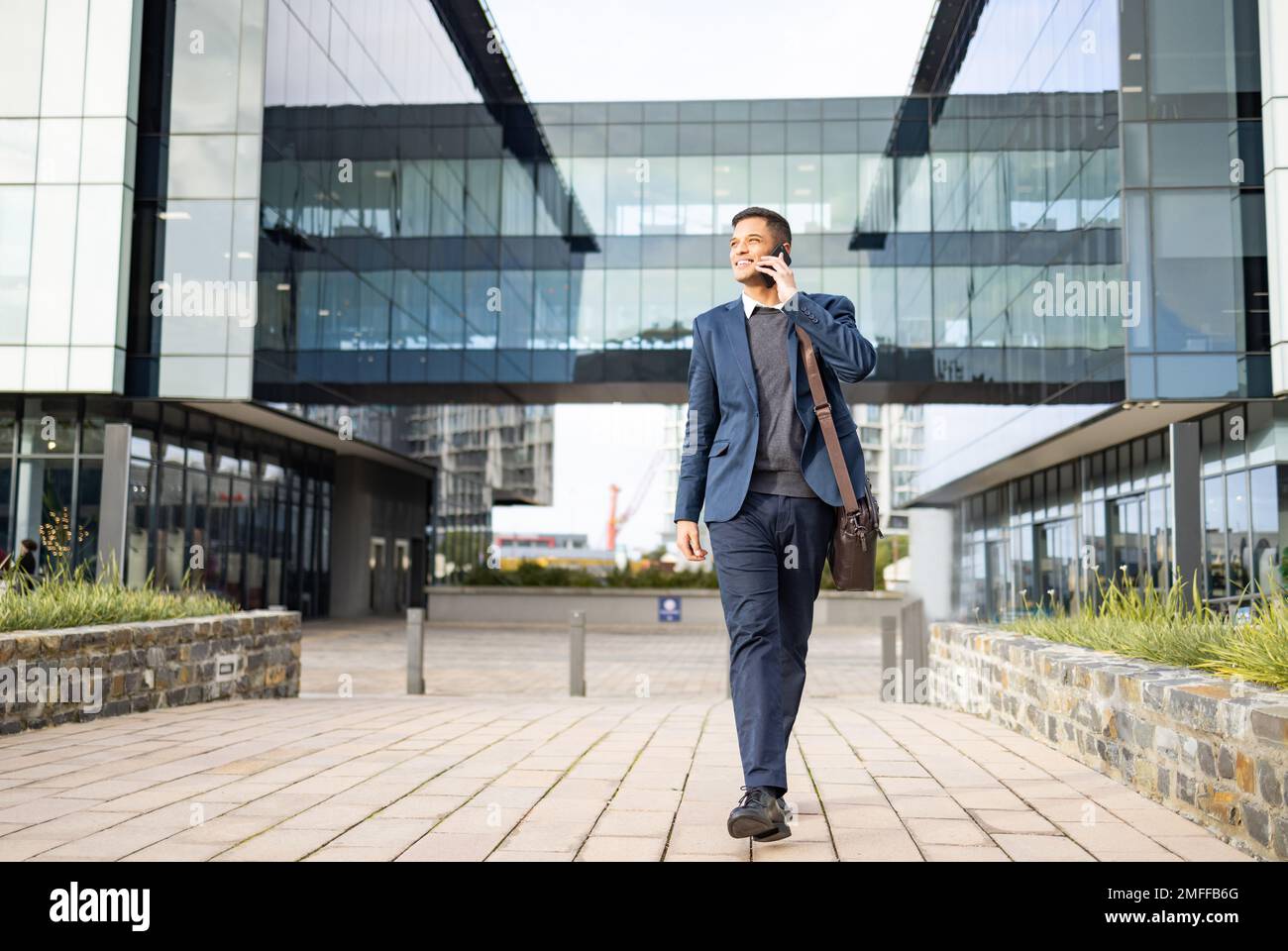 Phone call, communication and happy businessman walking, networking and ...