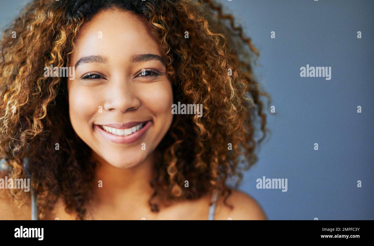 Smiling from dusk to dawn. Studio shot of an attractive young woman ...