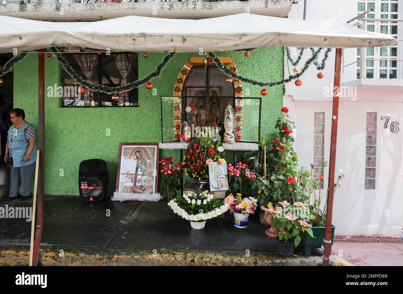 A makeshift altar honors the Virgin of Guadalupe outside a home in a ...