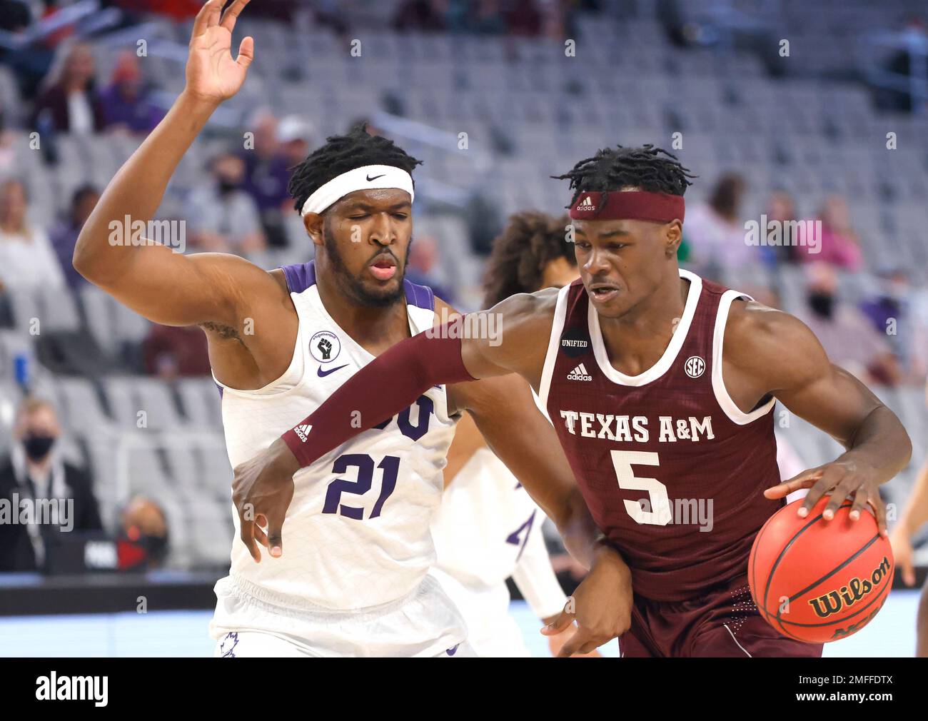 Texas A&M forward Emanuel Miller (5) drives inside as TCU center Kevin ...