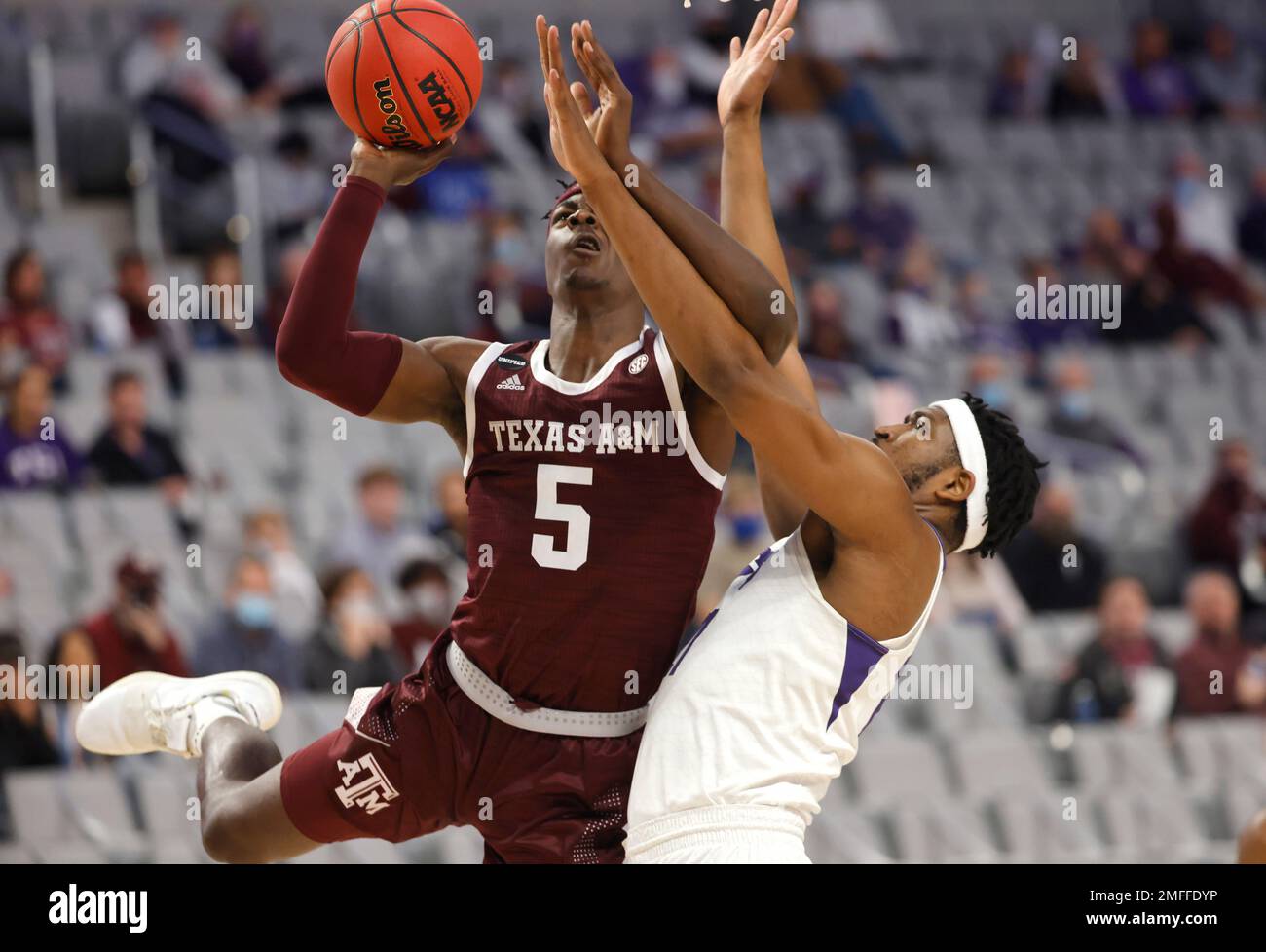 Texas A&M forward Emanuel Miller (5) goes inside to shoot as TCU center ...