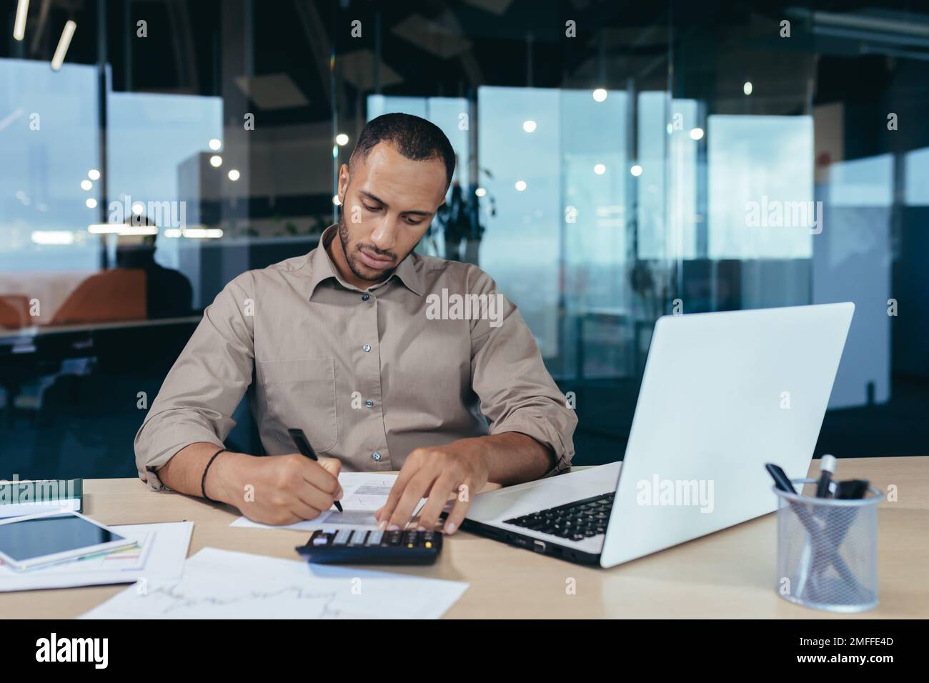 Concentrated young African American male accountant, auditor, banker ...