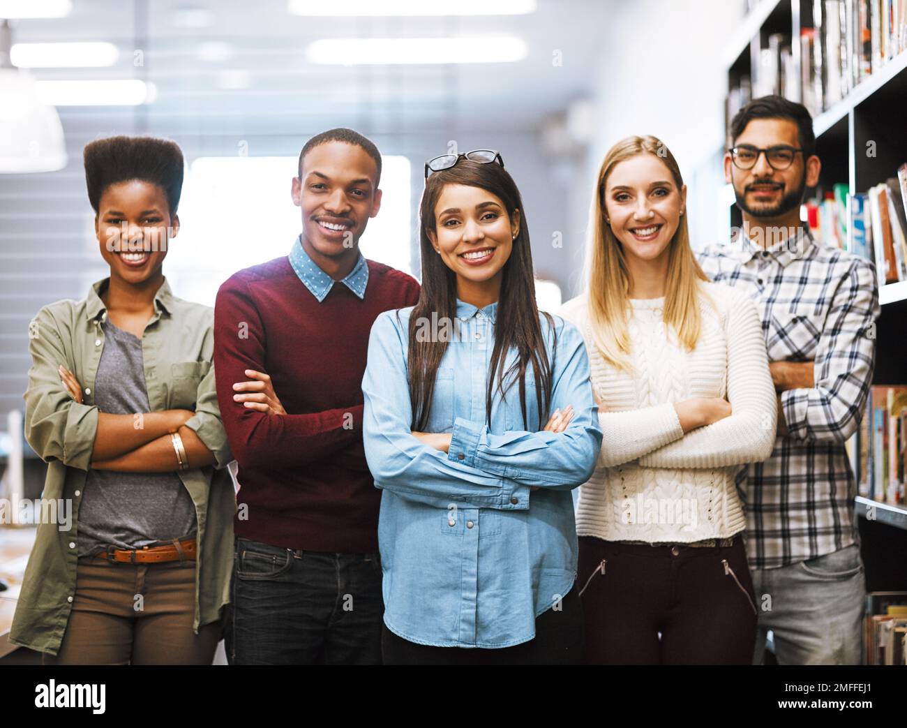 College is the place to be. university students standing in the library ...