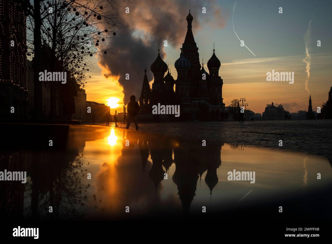 St. Basil Cathedral is reflected during a sunrise over Red Square in ...