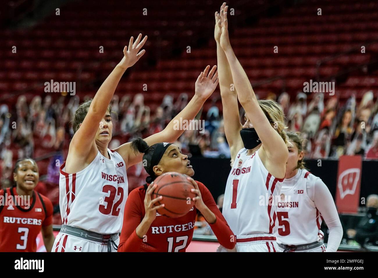 Rutgers' Sakima Walker (12) goes up against Wisconsin's Kate Thompson ...