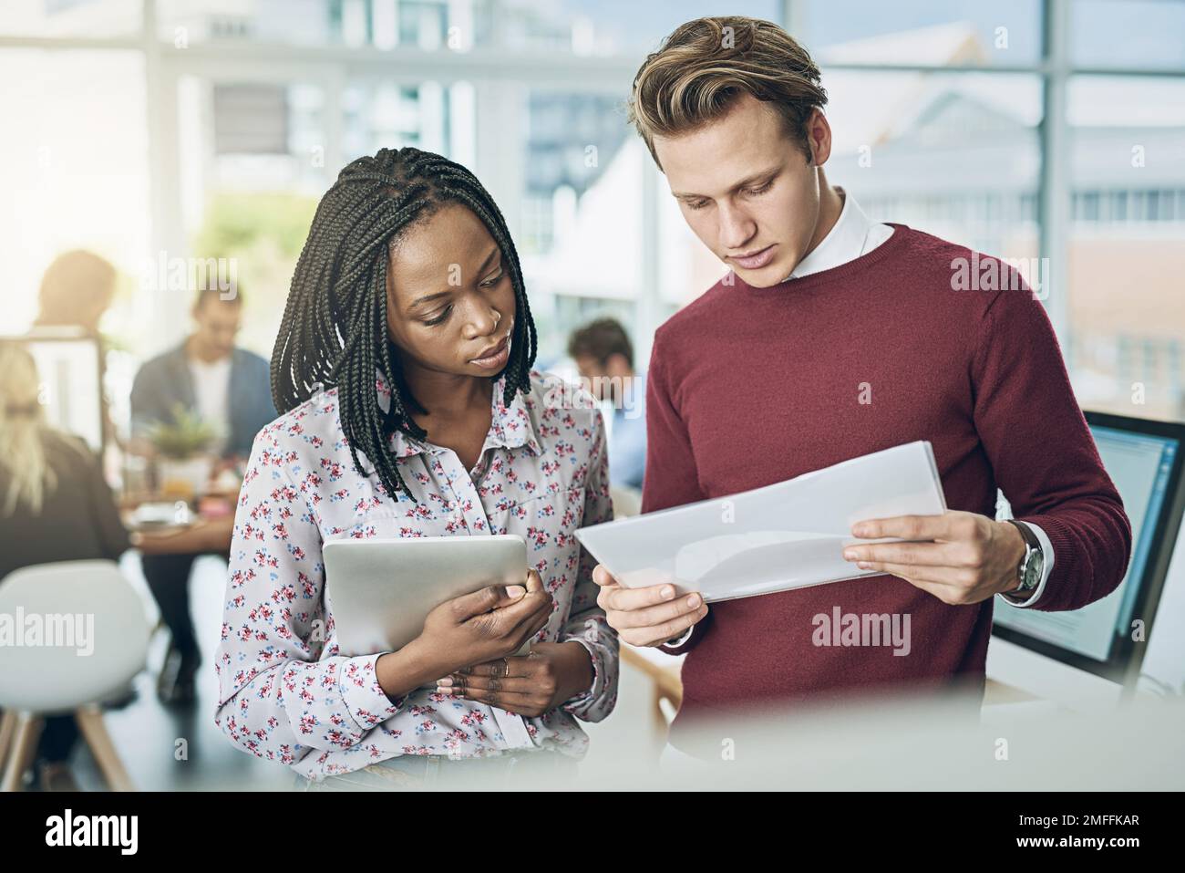 Double checking data with a trusted colleague. two young colleagues ...