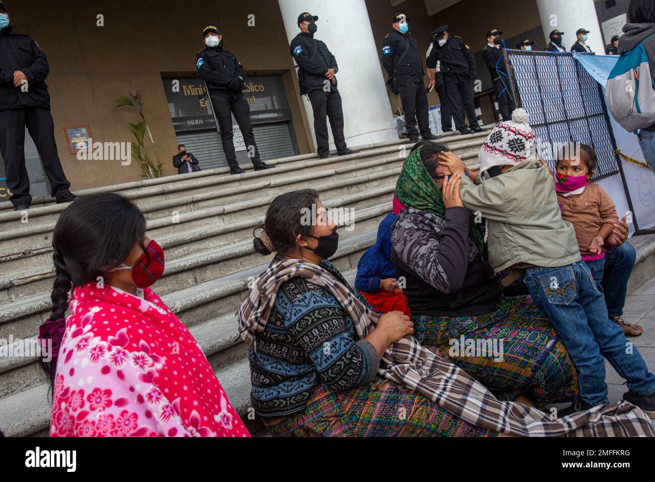 An indigenous woman plays with her son in front of the general attorney ...